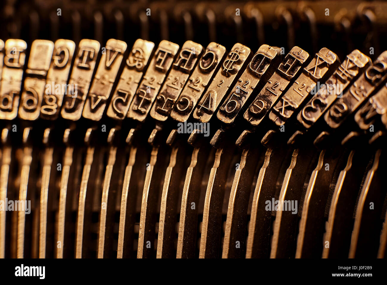 Closeup of old typewriter plates strikers with letters and symbols for ...