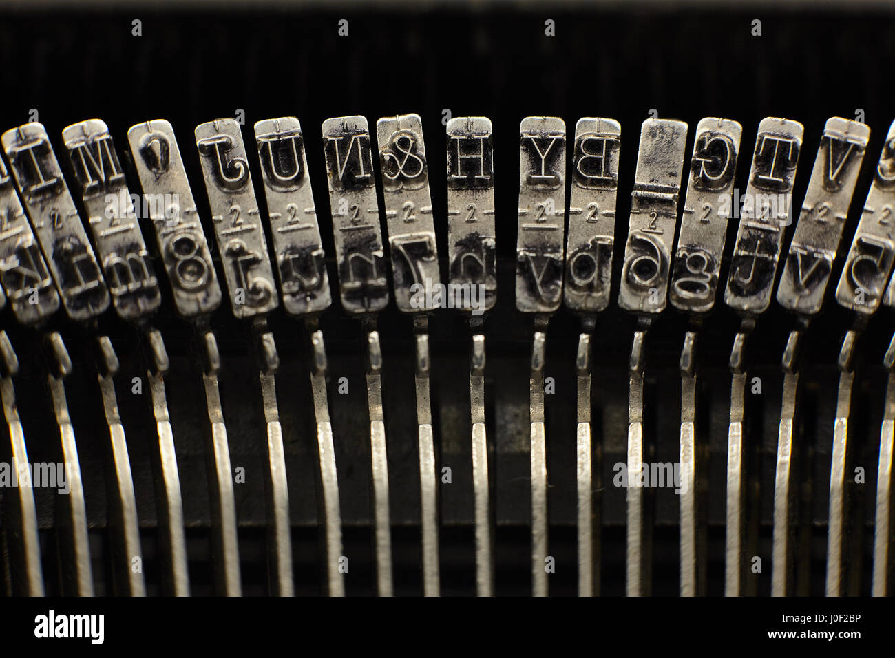 Closeup of old typewriter plates strikers with letters and symbols for ...