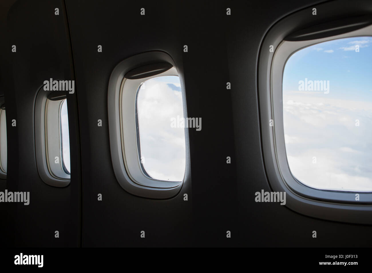 Row of three airplane windows Stock Photo - Alamy