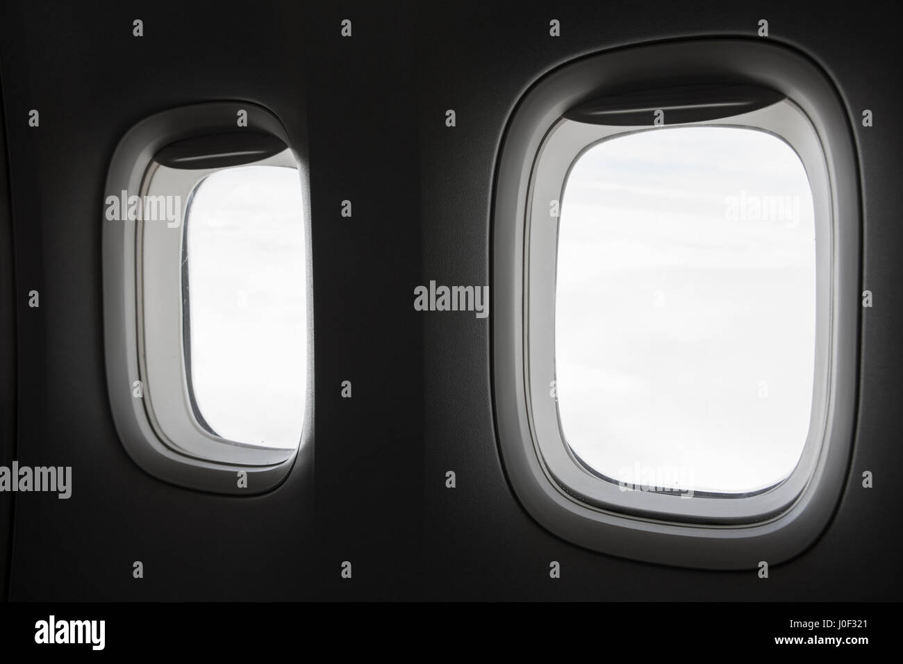 Two airplane windows Stock Photo - Alamy