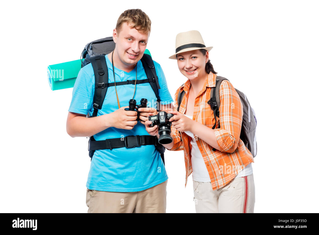 Cute young travelers with backpacks in studio Stock Photo - Alamy