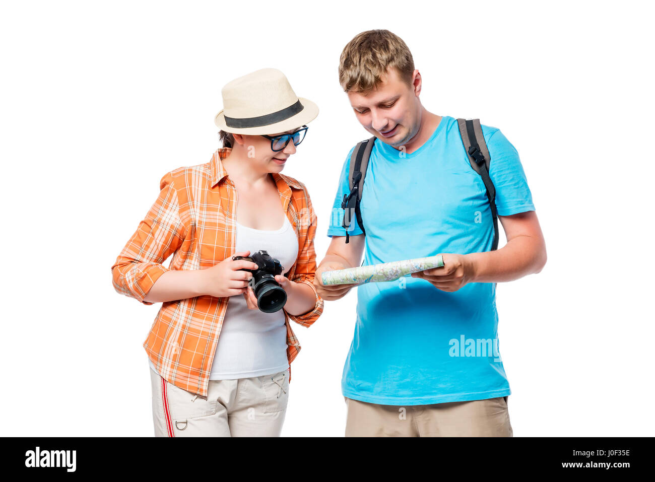 Girl photographer and male tourists looking at the map in the studio ...