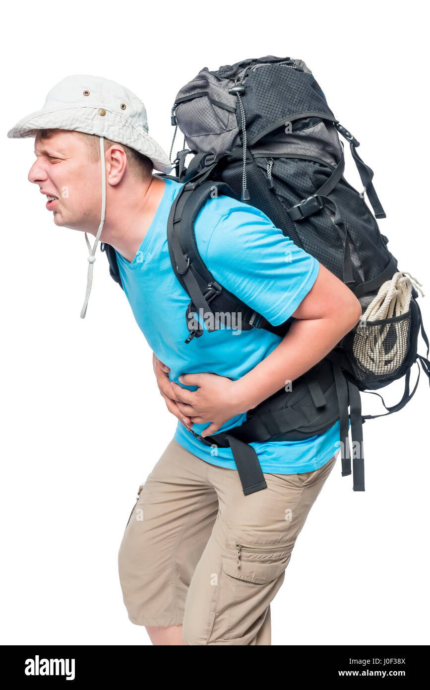 Young tourist with a backpack holding a sick stomach with hands on a ...