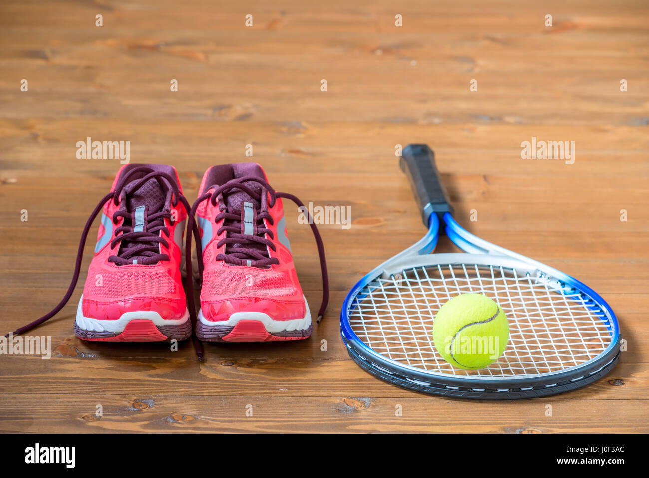 Set for playing tennis - sneakers, racket and ball on the floor Stock ...