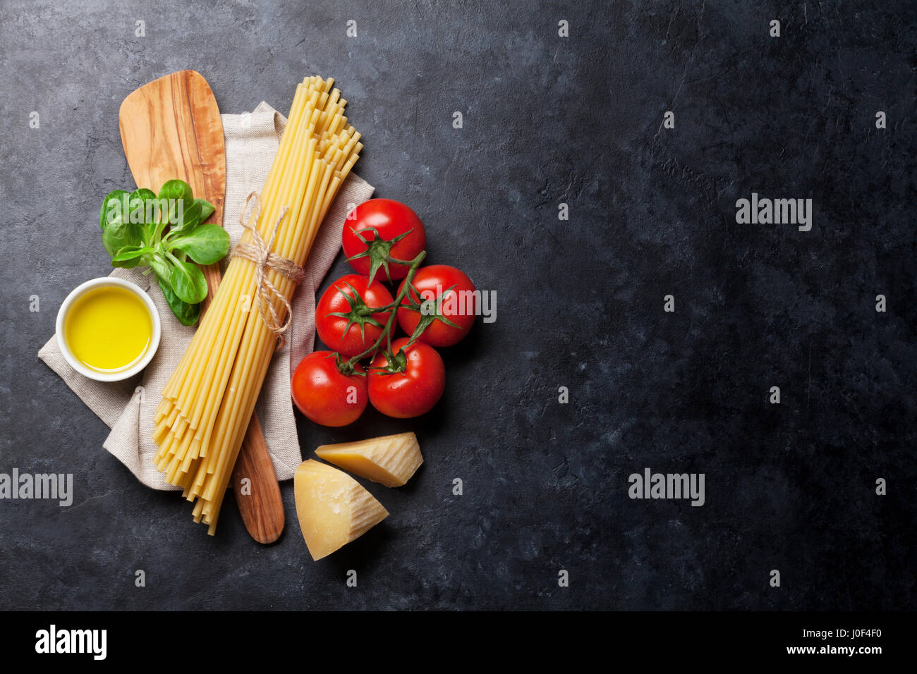 Pasta and ingredients on stone table. Top view with copy space Stock ...