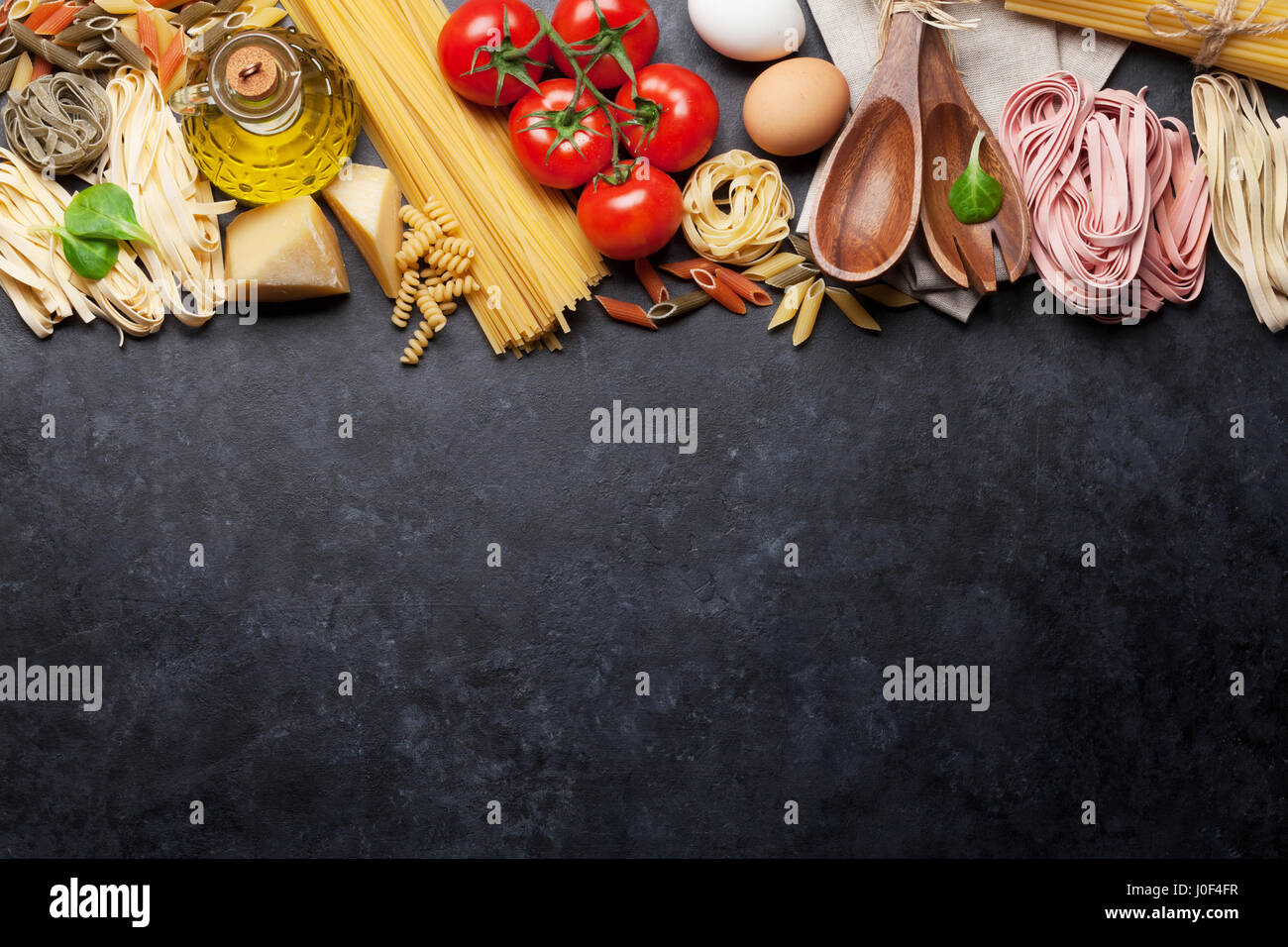 Pasta and ingredients on stone table. Top view with copy space Stock ...