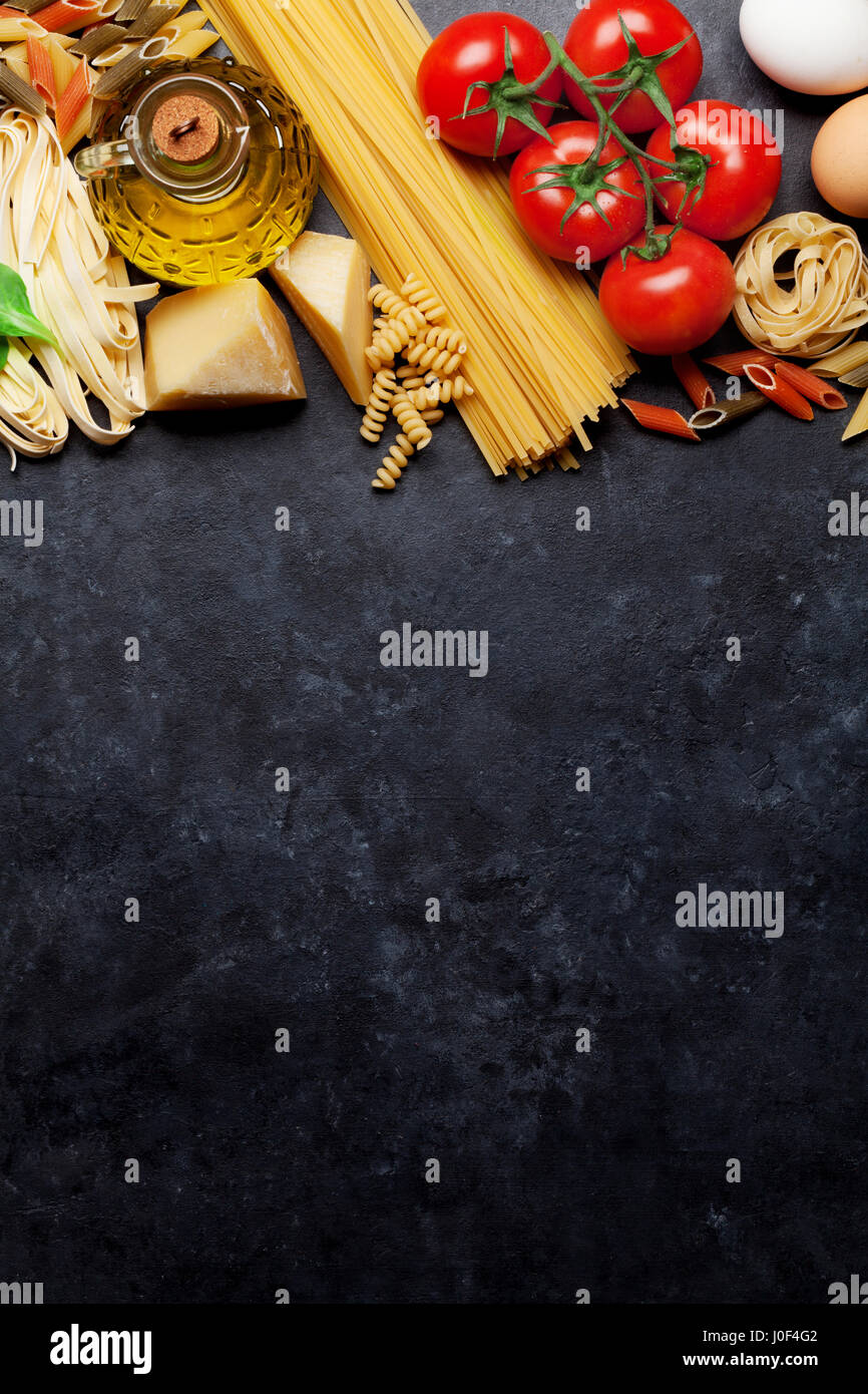 Pasta and ingredients on stone table. Top view with copy space Stock ...