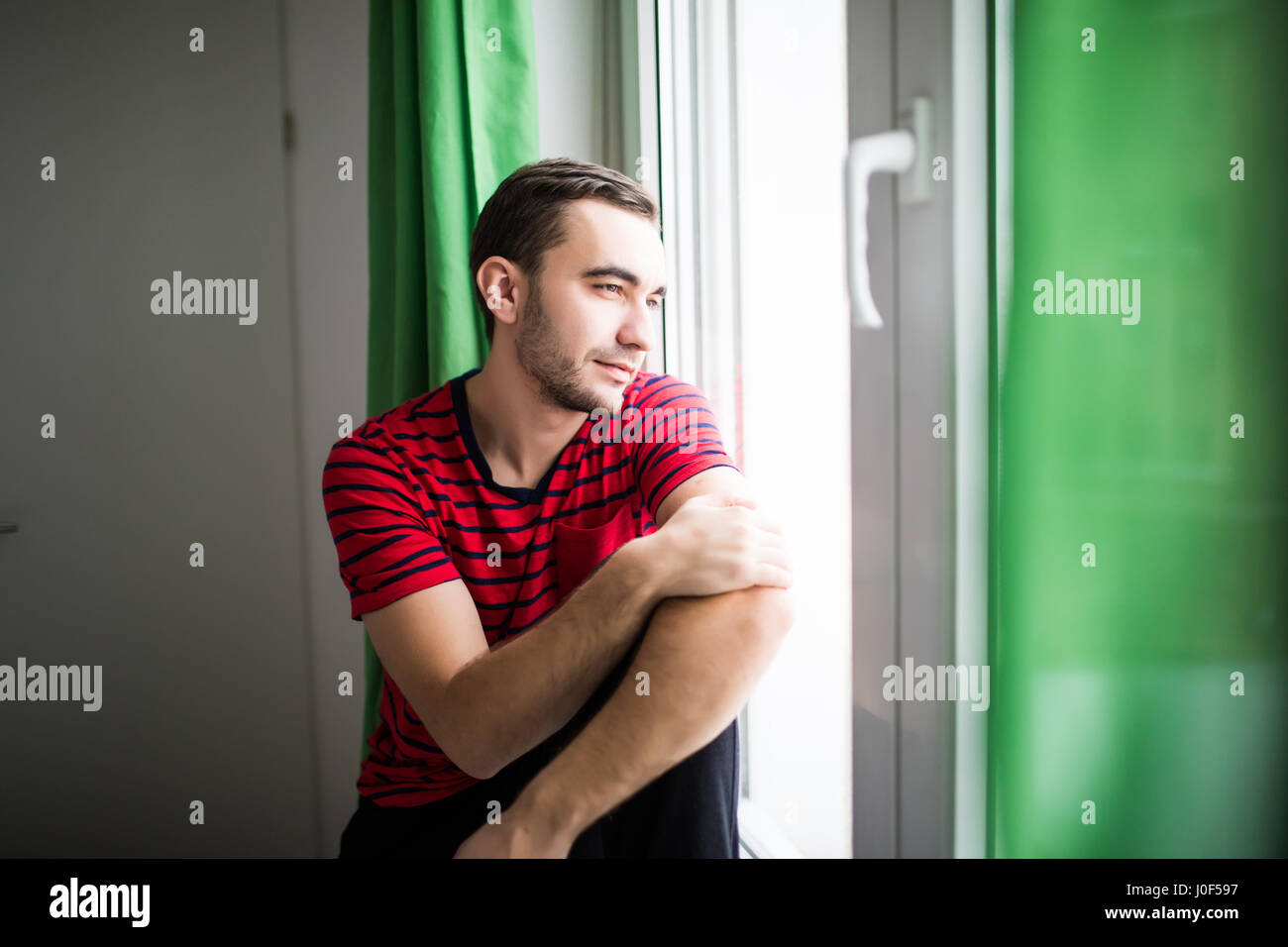 man standing by the window in the morning Stock Photo - Alamy