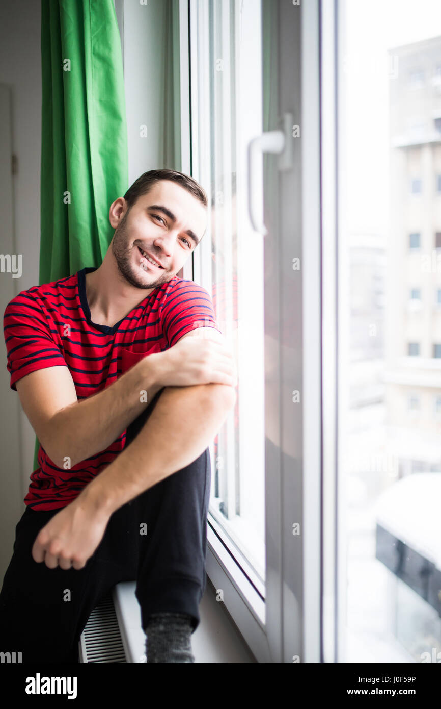 Man sitting window in pajamas hi-res stock photography and images - Alamy