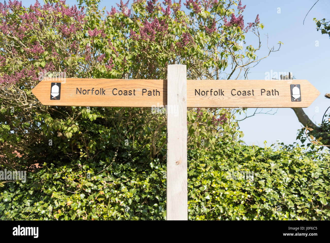 A signpost for the Norfolk Coast Path giving directions for walkers ...