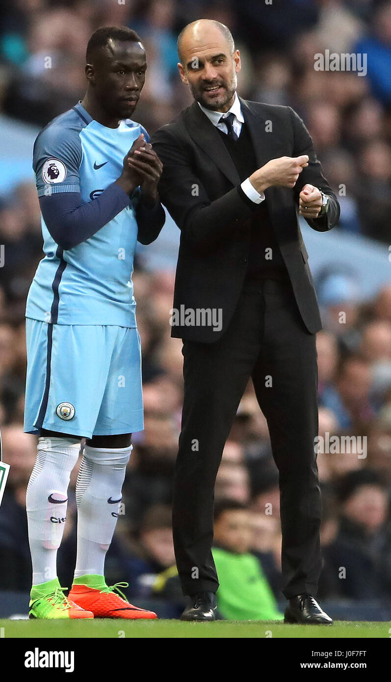 Manchester City manager Pep Guardiola (right) talks tactics to Bacary ...