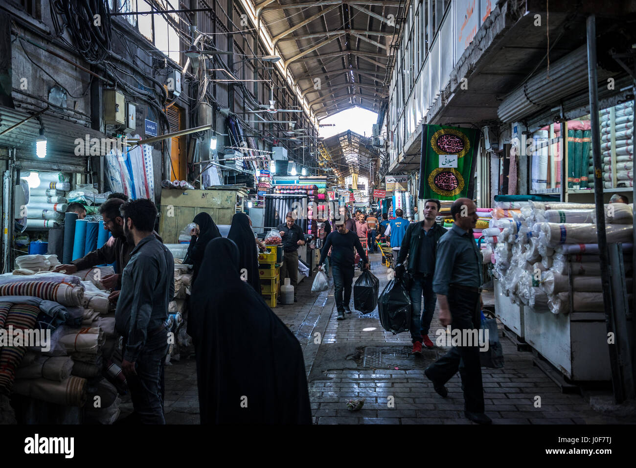 Alleyway full of shops with textiles for sale on the Grand Bazaar in ...