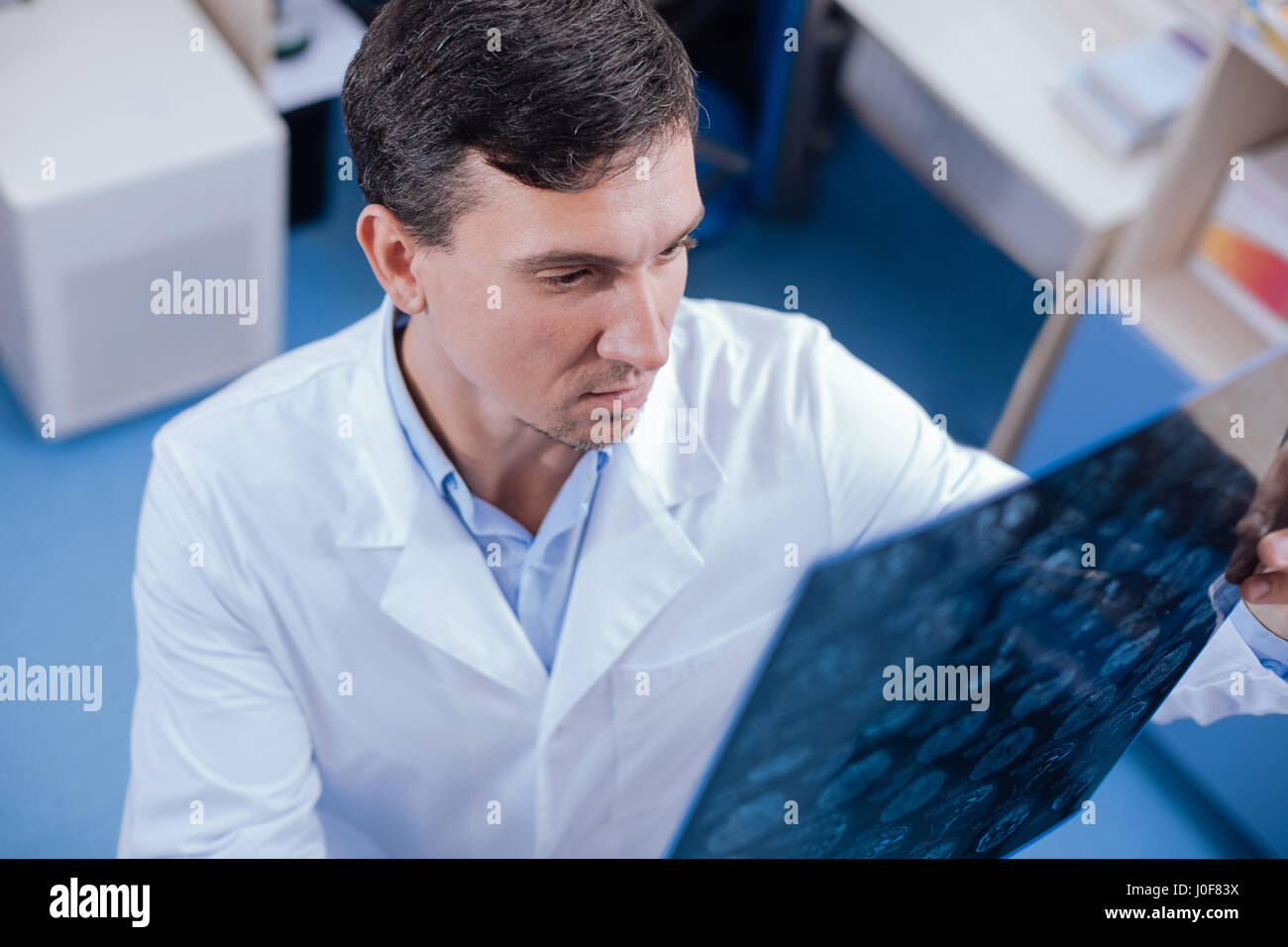 Serious experienced doctor holding the radiograph Stock Photo - Alamy