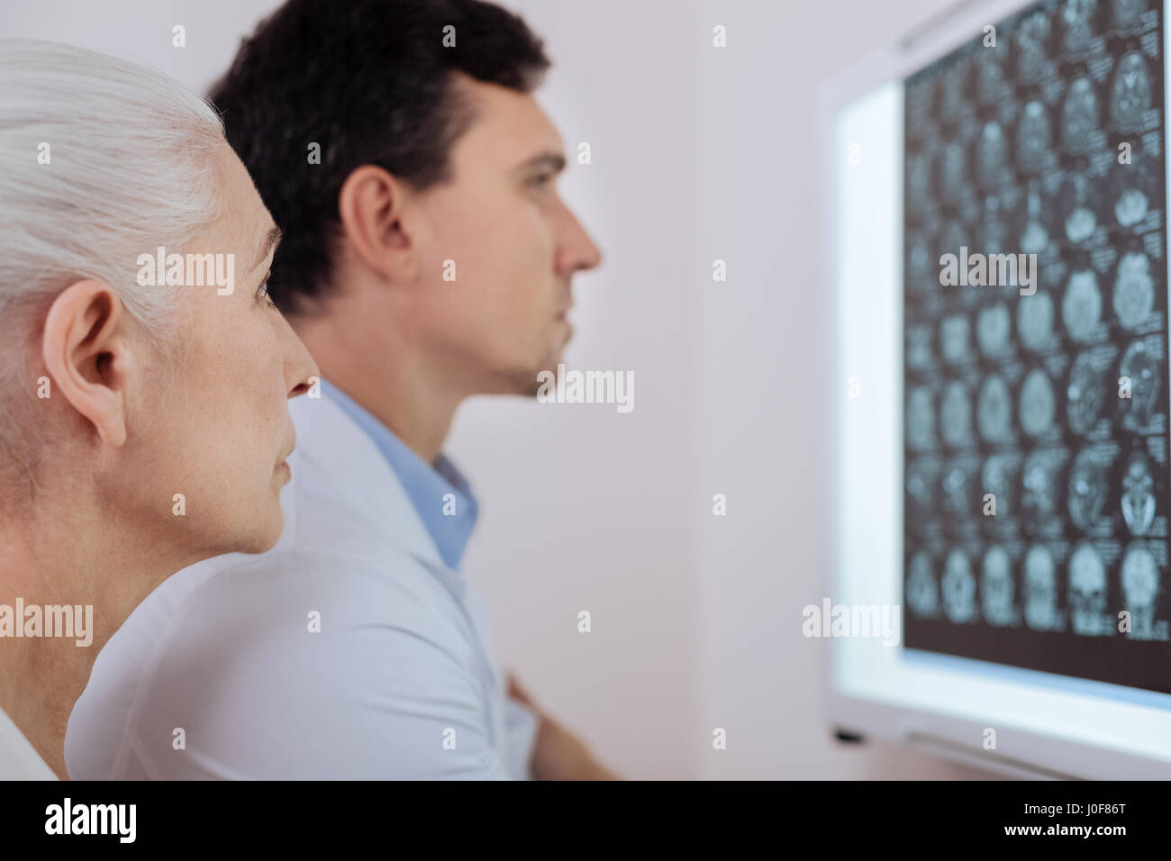 Serious elderly woman visiting an oncologist Stock Photo - Alamy