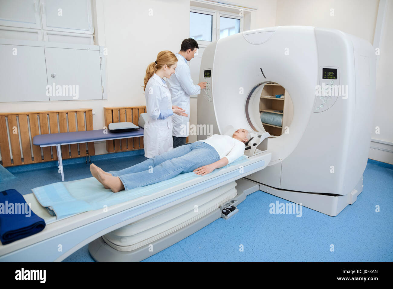 Nice professional doctors using a CT scanner Stock Photo - Alamy