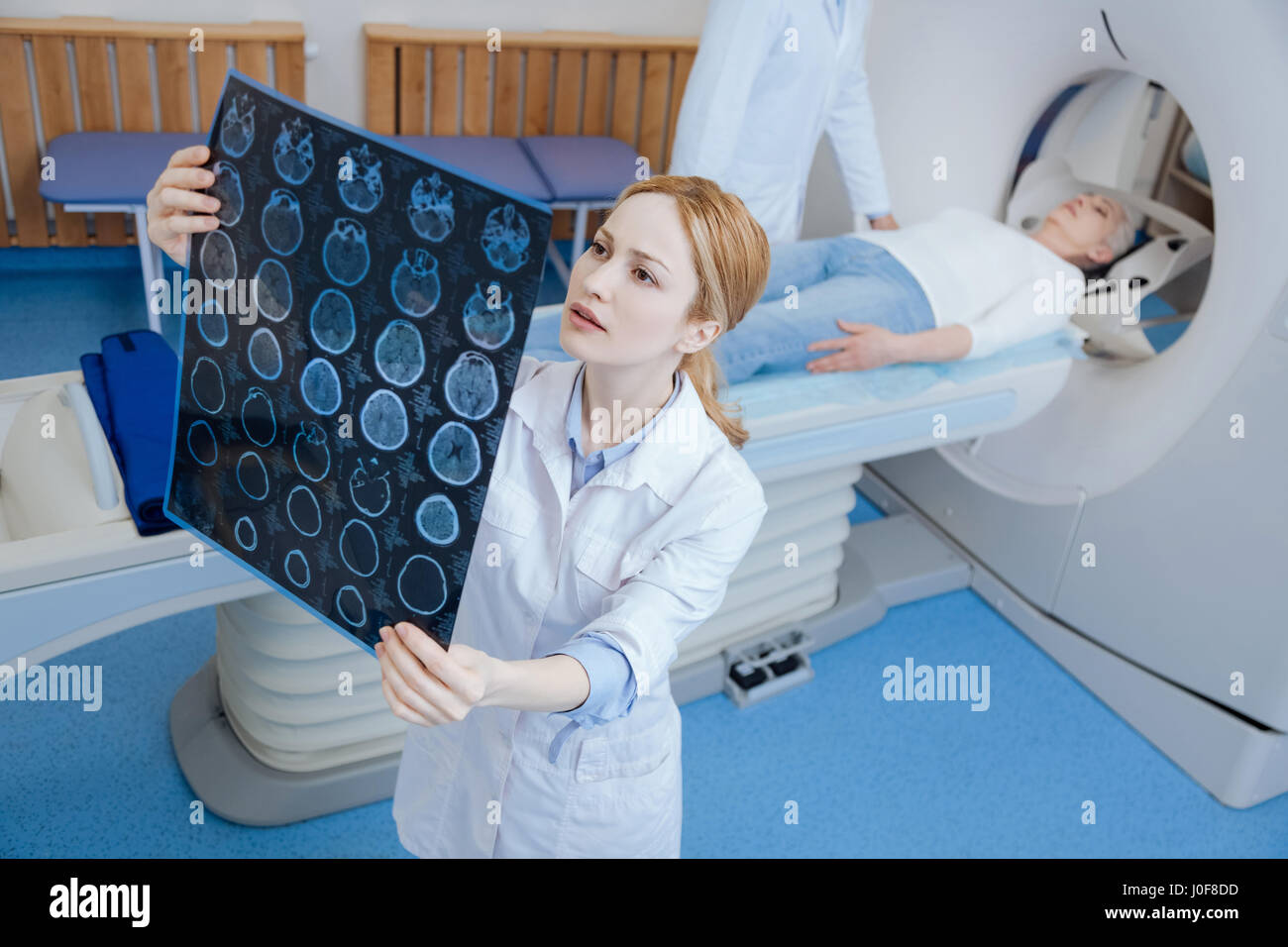 Beautiful female radiologist looking at the MRI scan images Stock Photo ...