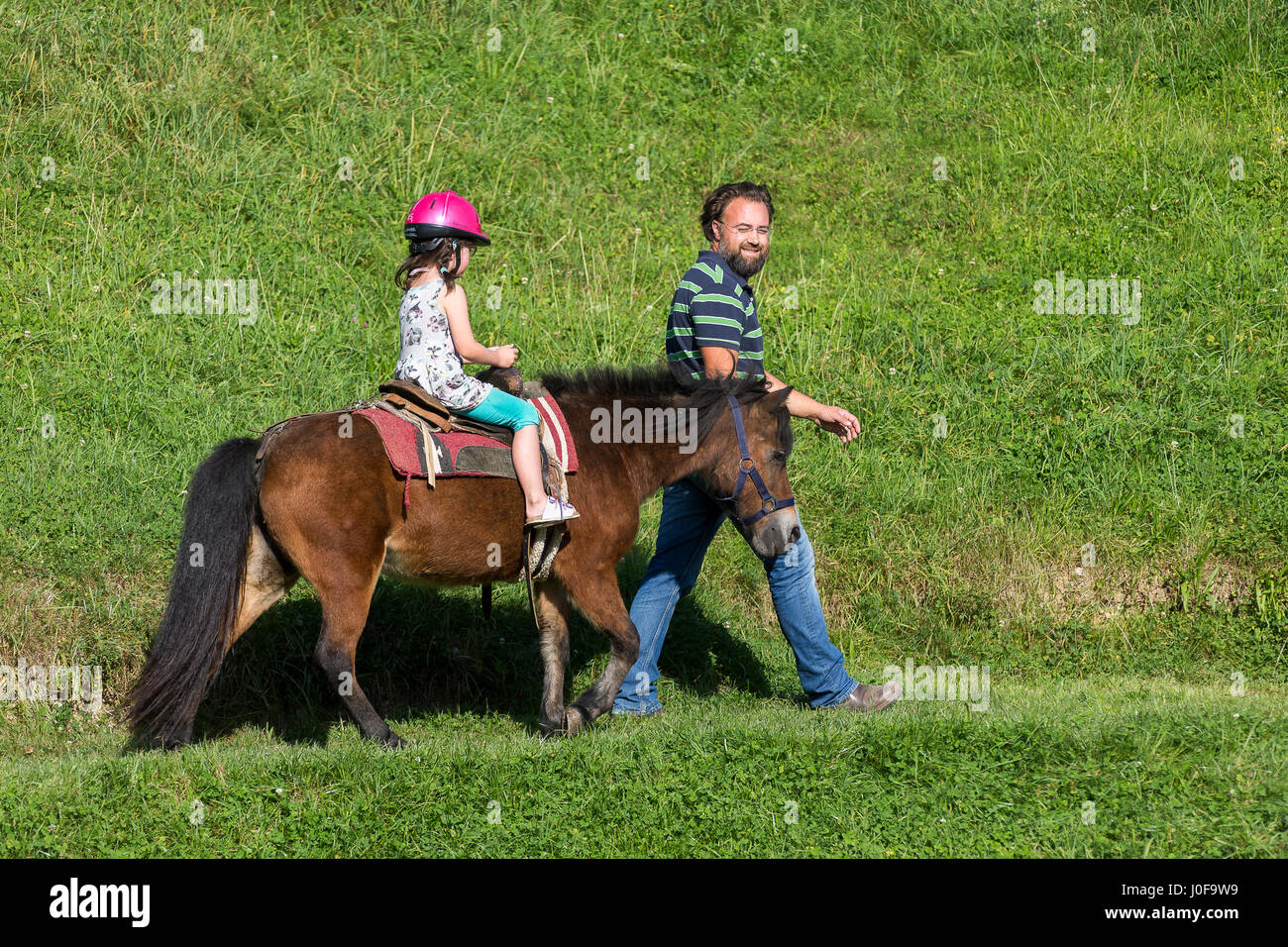 Woman leading child pony hi-res stock photography and images - Alamy