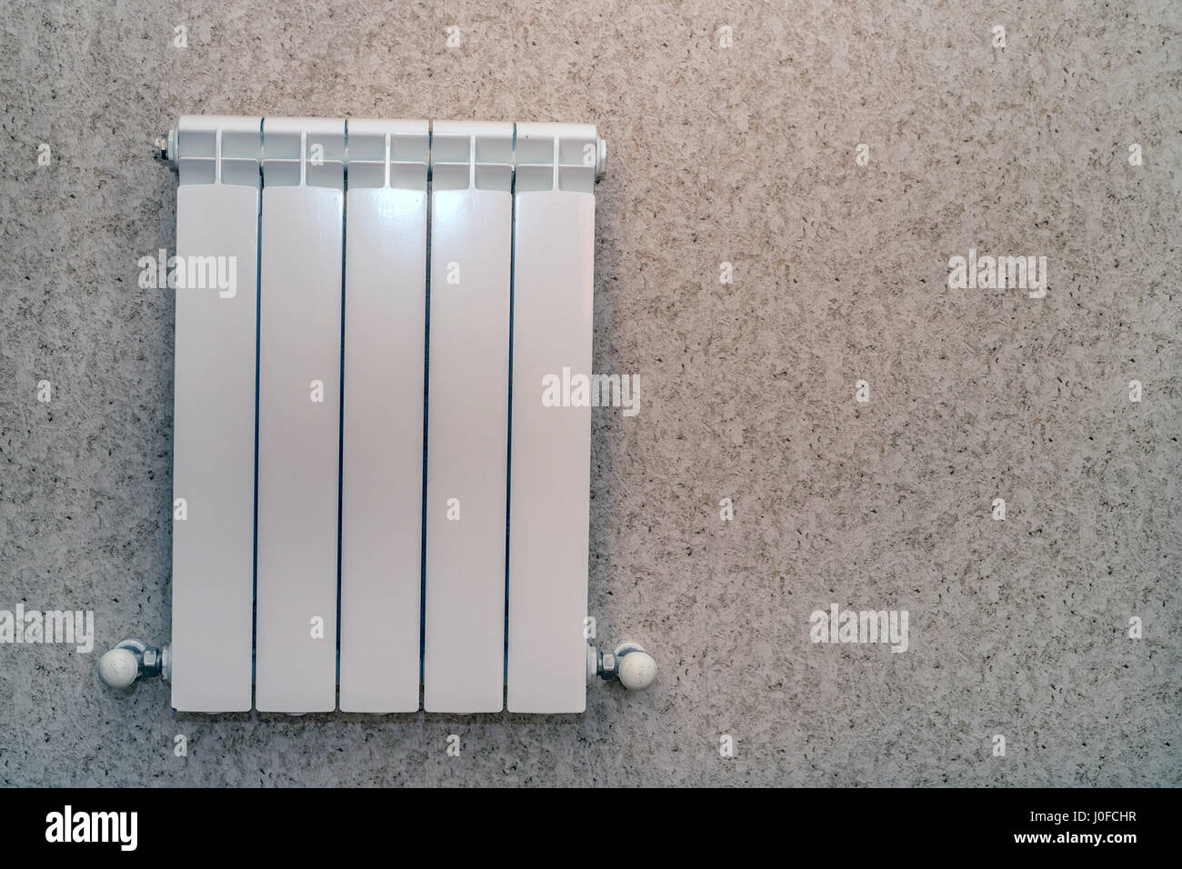 Close-up of modern hot water baseboard radiator Stock Photo - Alamy