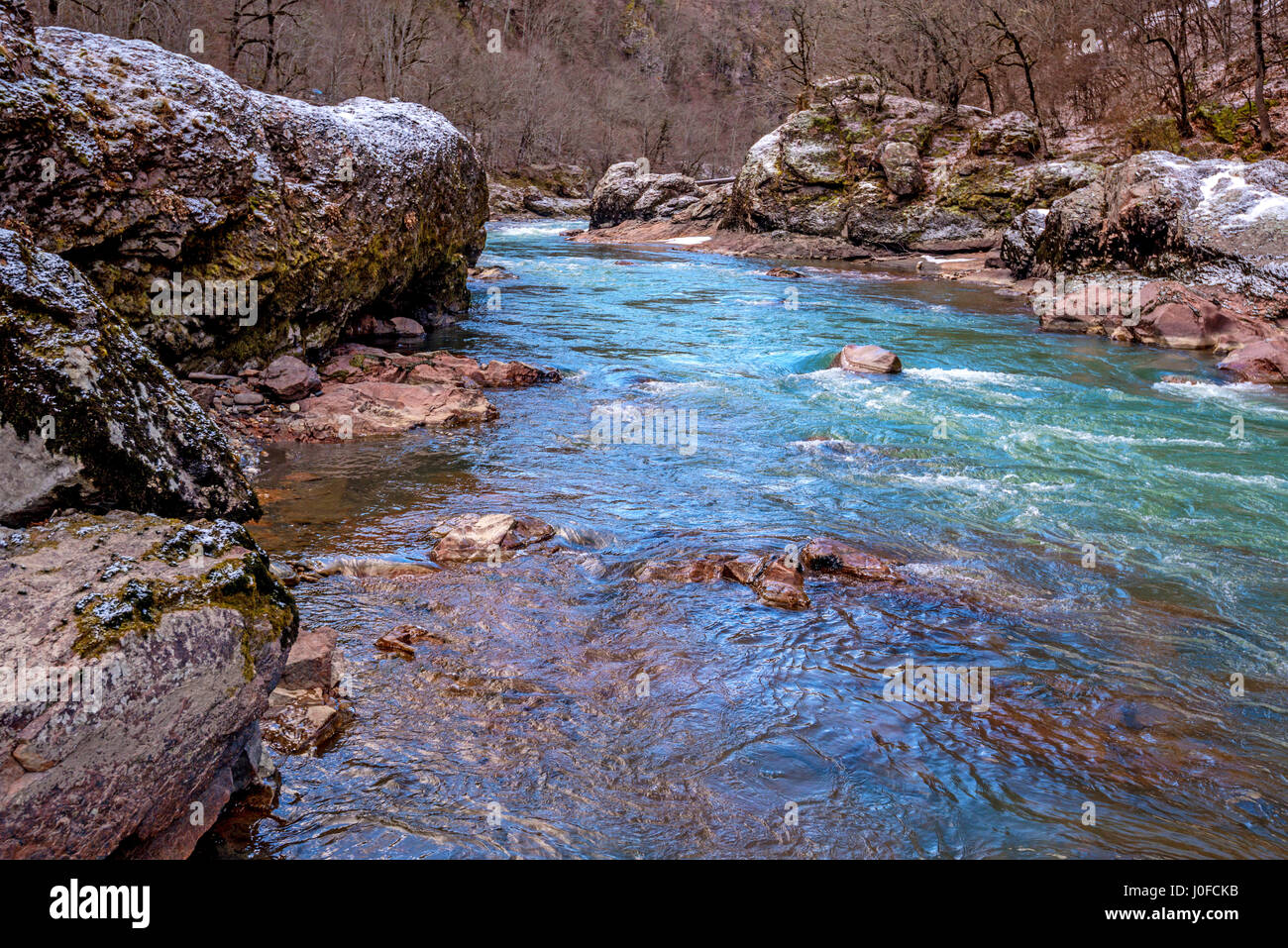 Beautiful winter landscape with turquoise mountain river and granite ...