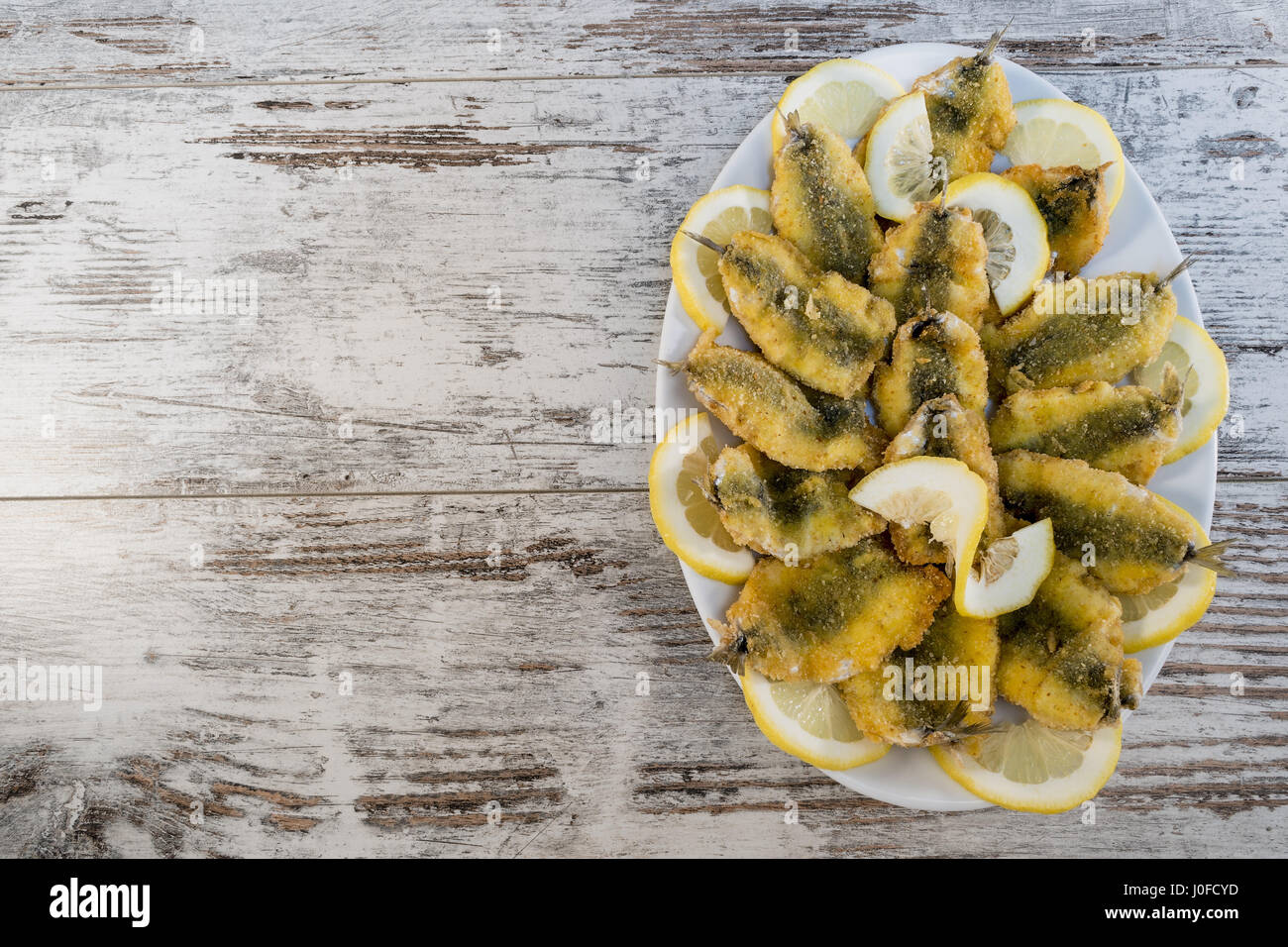 fried sardines oval top plate dx Stock Photo - Alamy