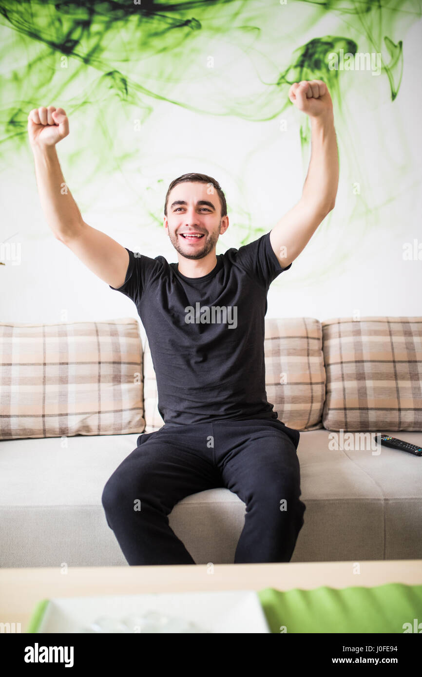 Handsome man celebrating victory of his team Stock Photo - Alamy