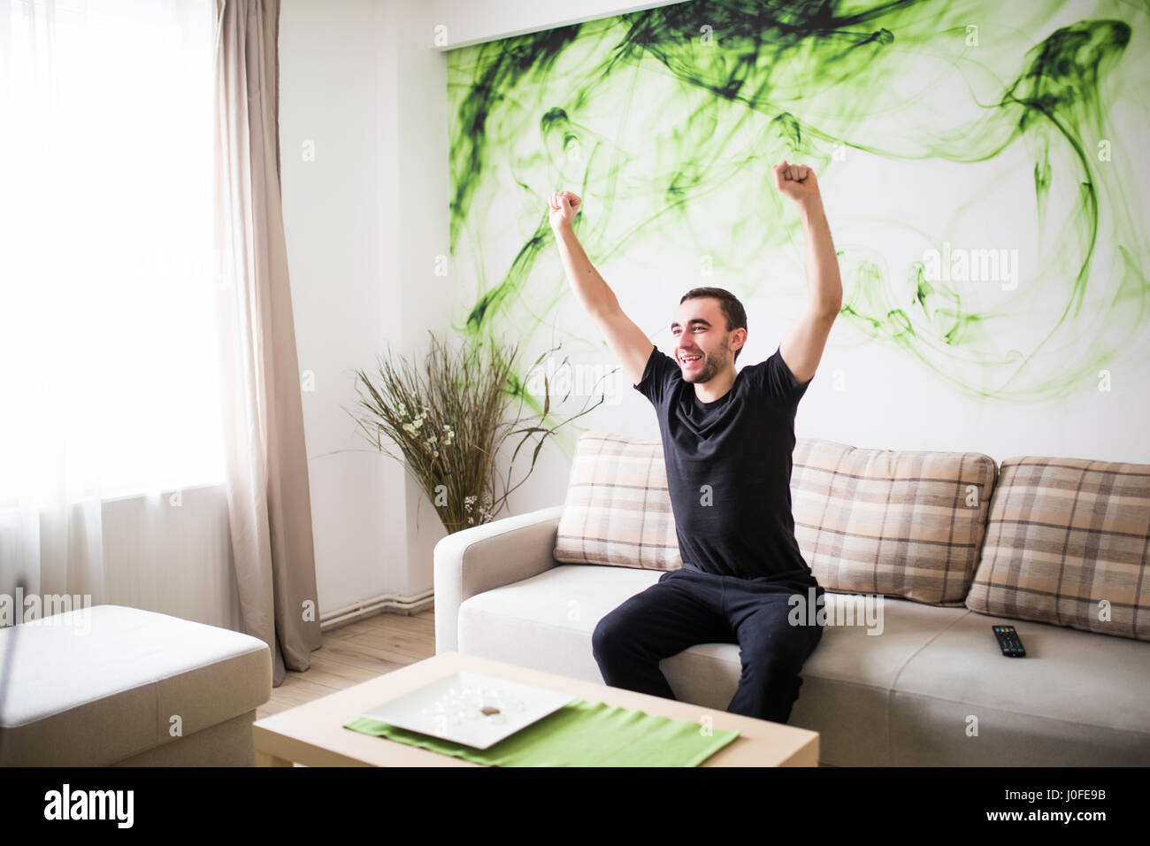 Handsome man celebrating victory of his team Stock Photo - Alamy