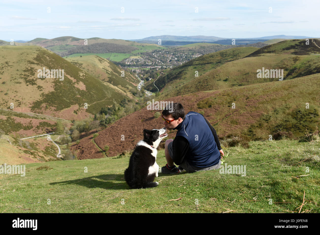 One man and his puppy dog on The Long Mynd Carding Mill Valley in South ...