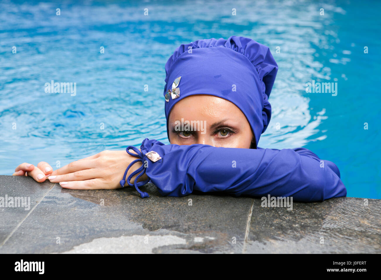 Attractive woman in a Muslim swimwear burkini in the pool Stock Photo ...