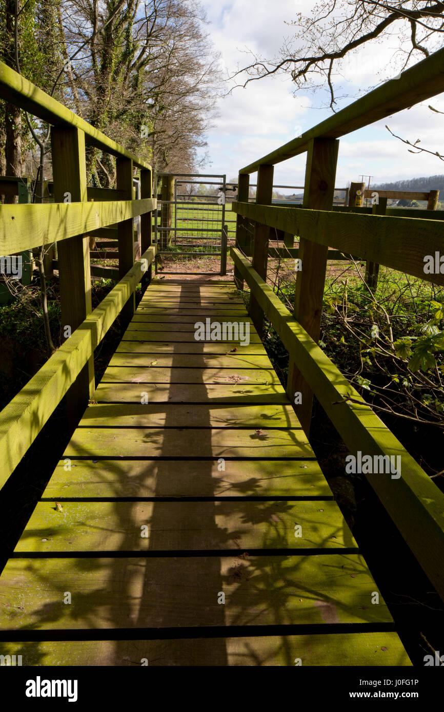 Modern footbridge on path crossing a stream in Herefordshire. The path ...