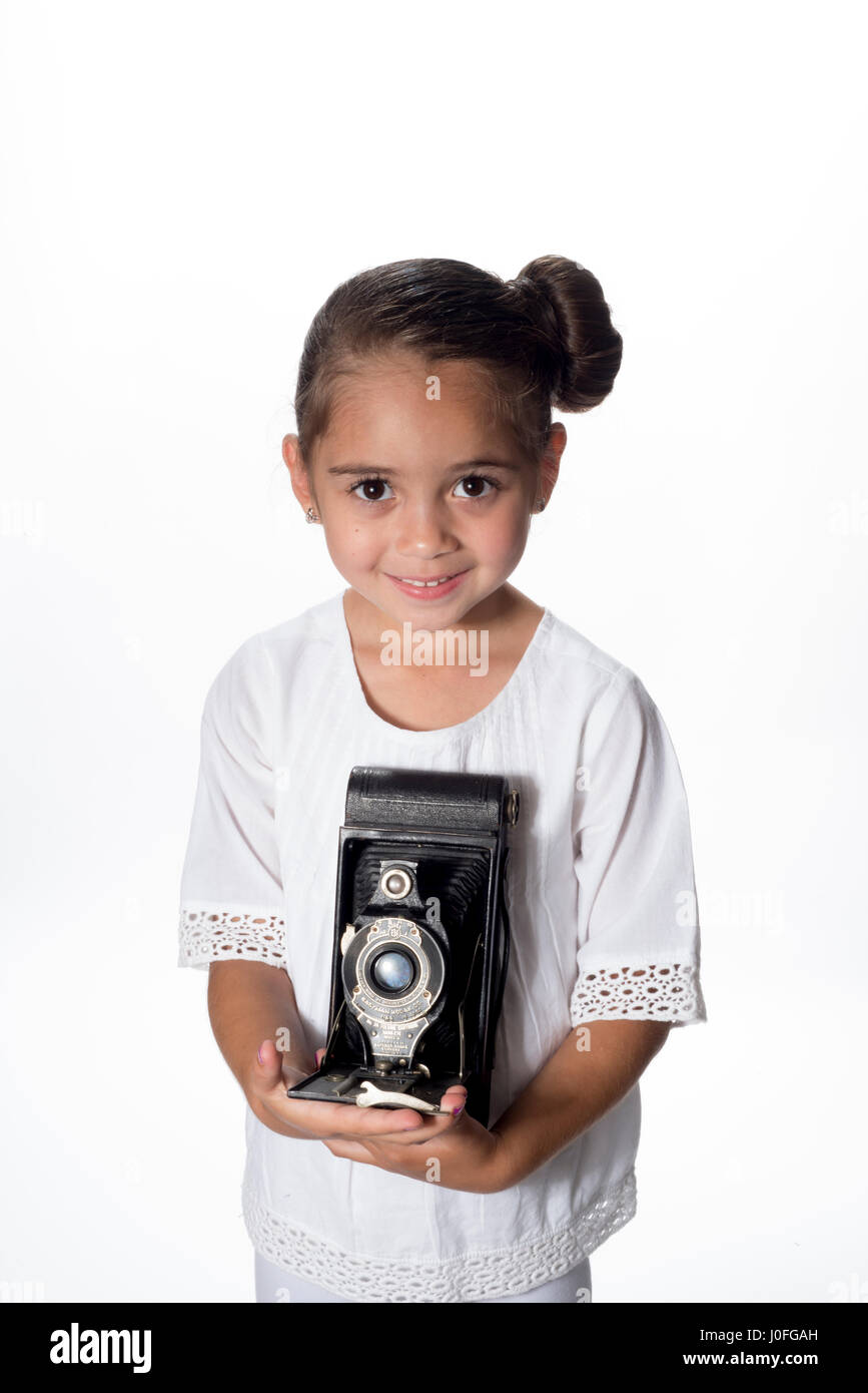 young girl modeling in studio holding classic camera Stock Photo - Alamy