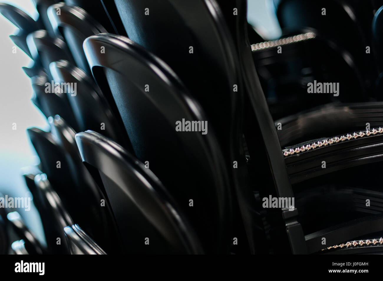 A stack of black chair backstage Stock Photo - Alamy