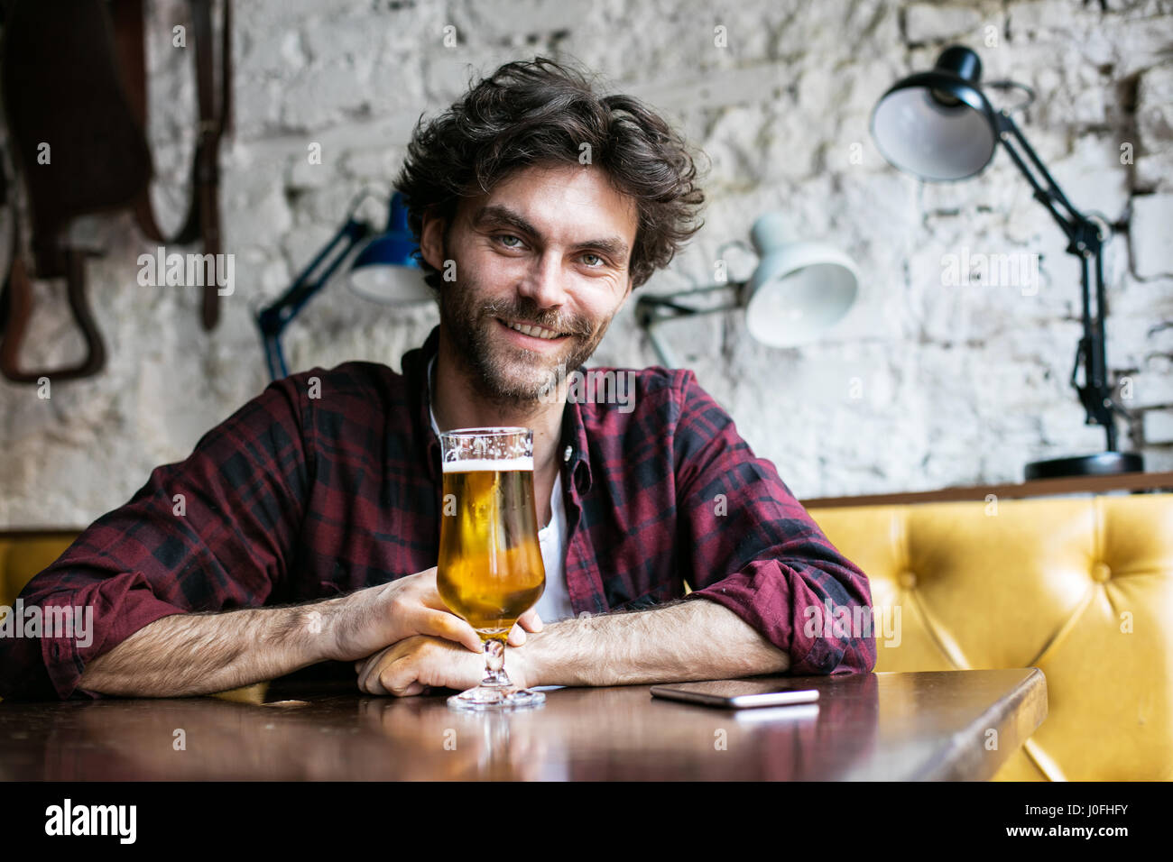 Man sitting in a pub drinking a pint of beer hi-res stock photography ...