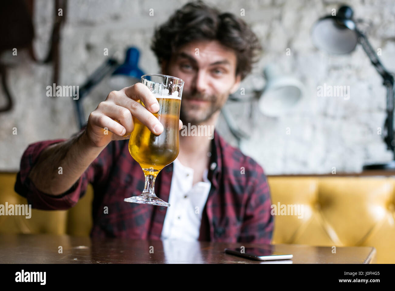 Man sitting in a pub drinking a pint of beer hi-res stock photography ...