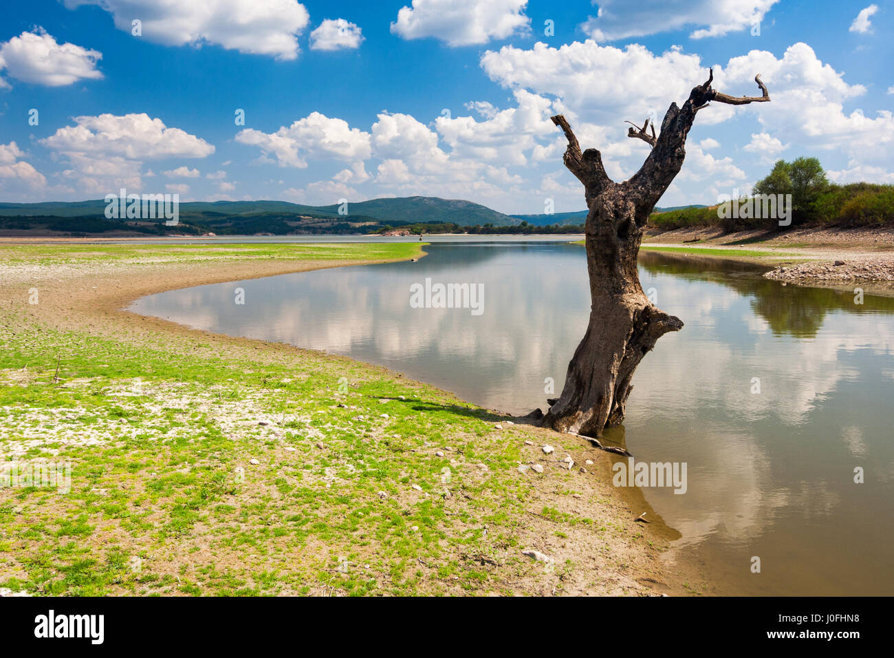 Picturesque daylight scene by a lake with bright blue sky and white ...