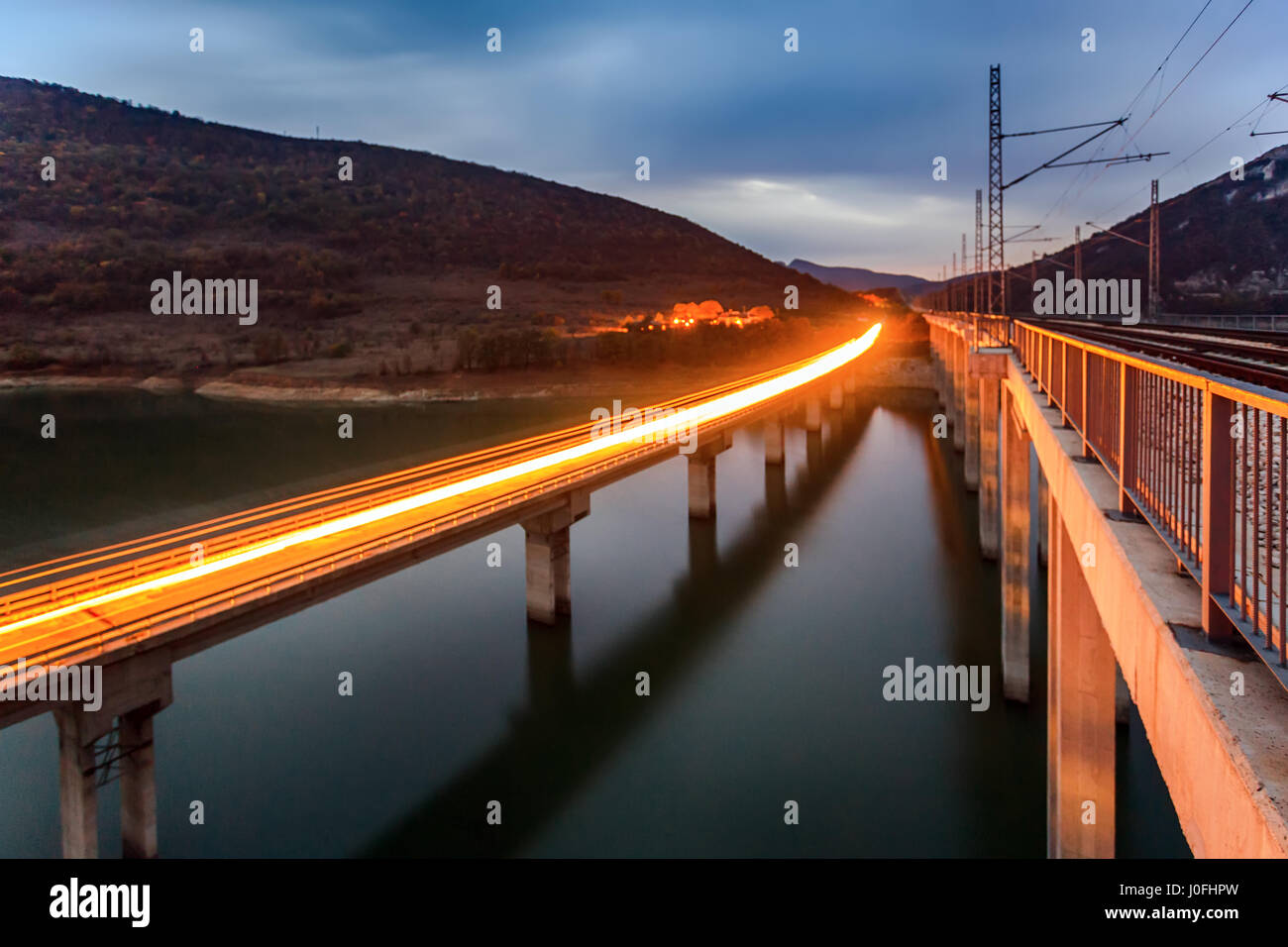 Traffic lights trough a bridge over a lake at night Stock Photo - Alamy
