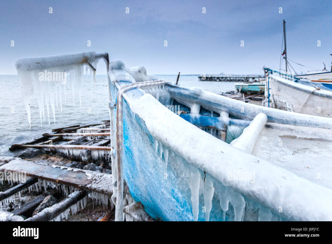 Frozen fishing boat with icicles in a port Stock Photo - Alamy