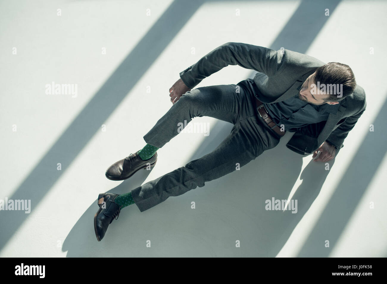overhead view of handsome stylish man lying on floor Stock Photo - Alamy