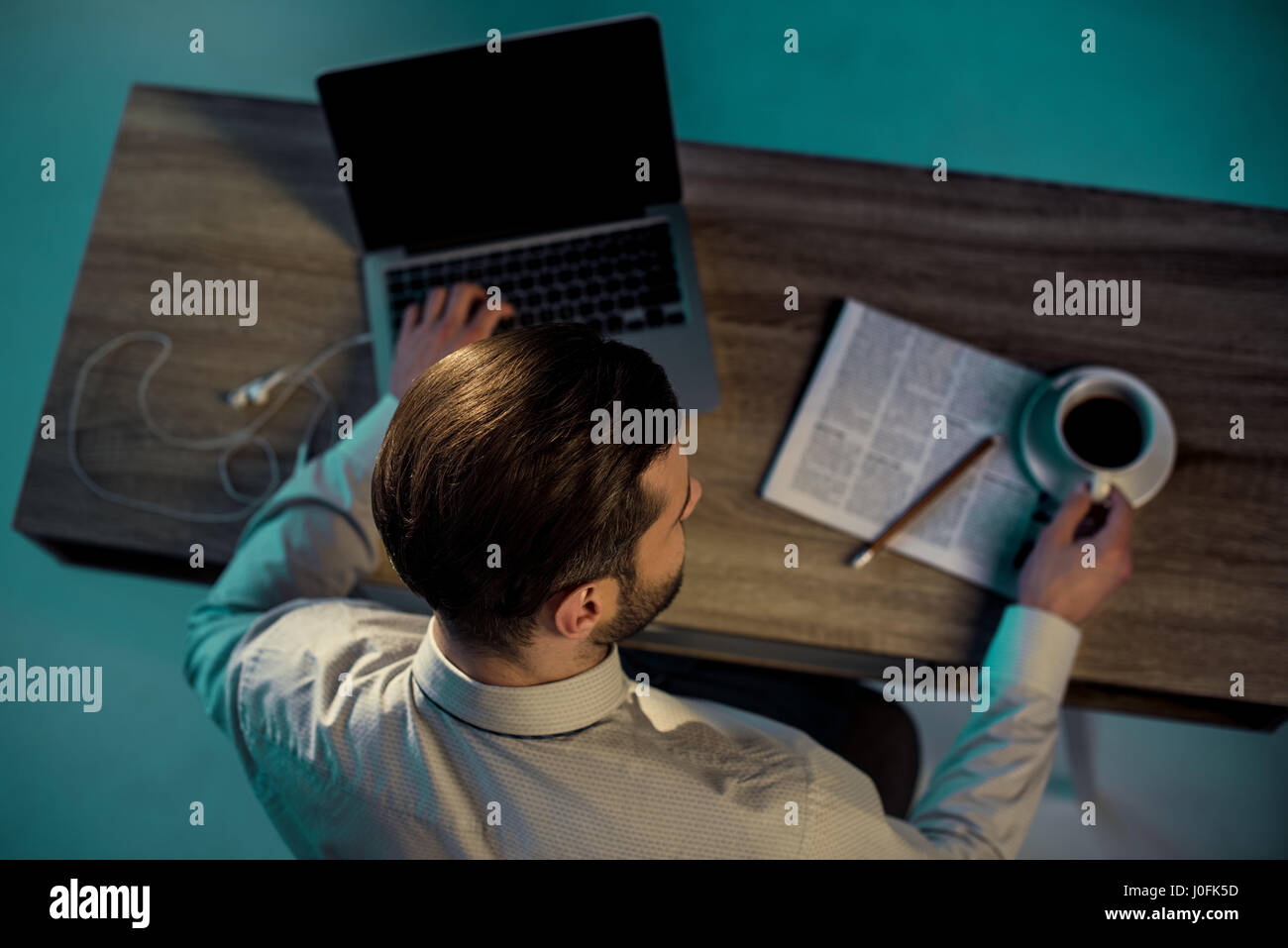 Overhead view of man working by office table Stock Photo - Alamy