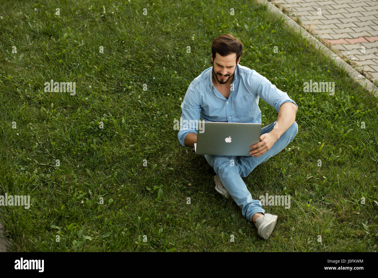 Handsome man sitting down outside hi-res stock photography and images ...