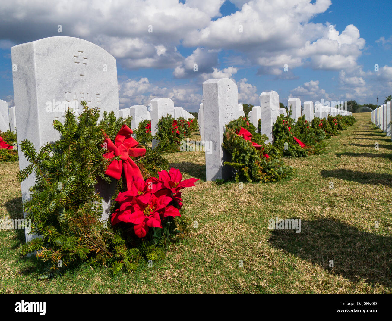 Rows of grave stones with wreaths & red bows in Sarasota National ...