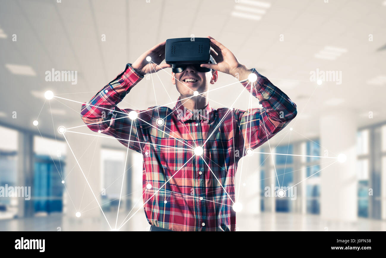 Guy wearing checked shirt and virtual mask demonstrating some em Stock ...