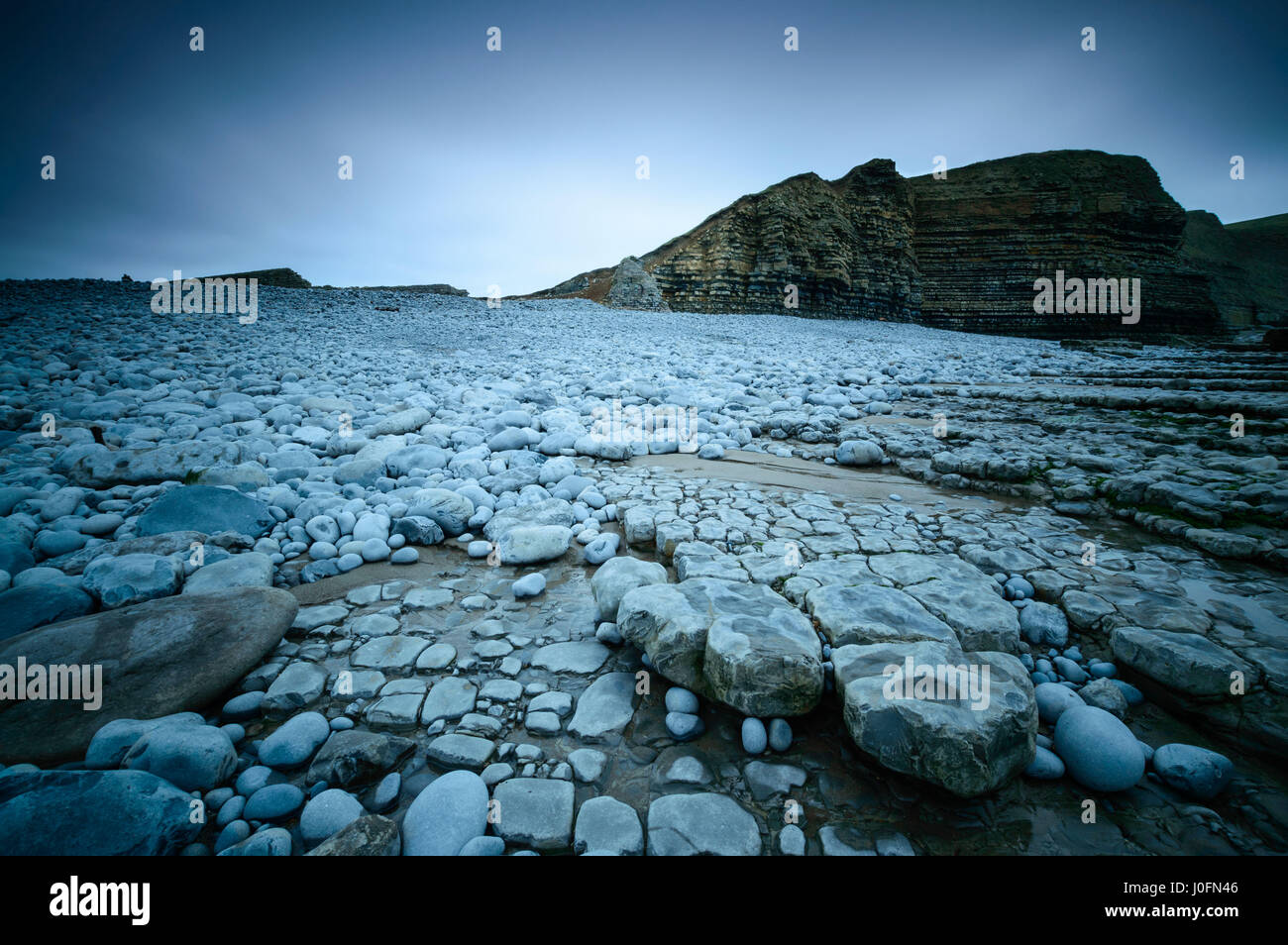 Pebbles and rock shelves on the beach at Dunraven Bay, Glamorgan Caost ...