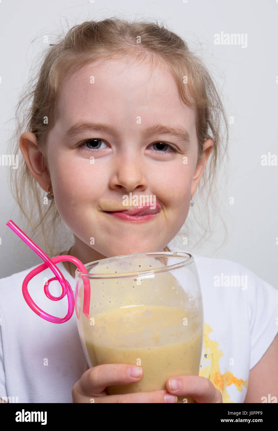 child drinks from a glass of milkshake Stock Photo - Alamy
