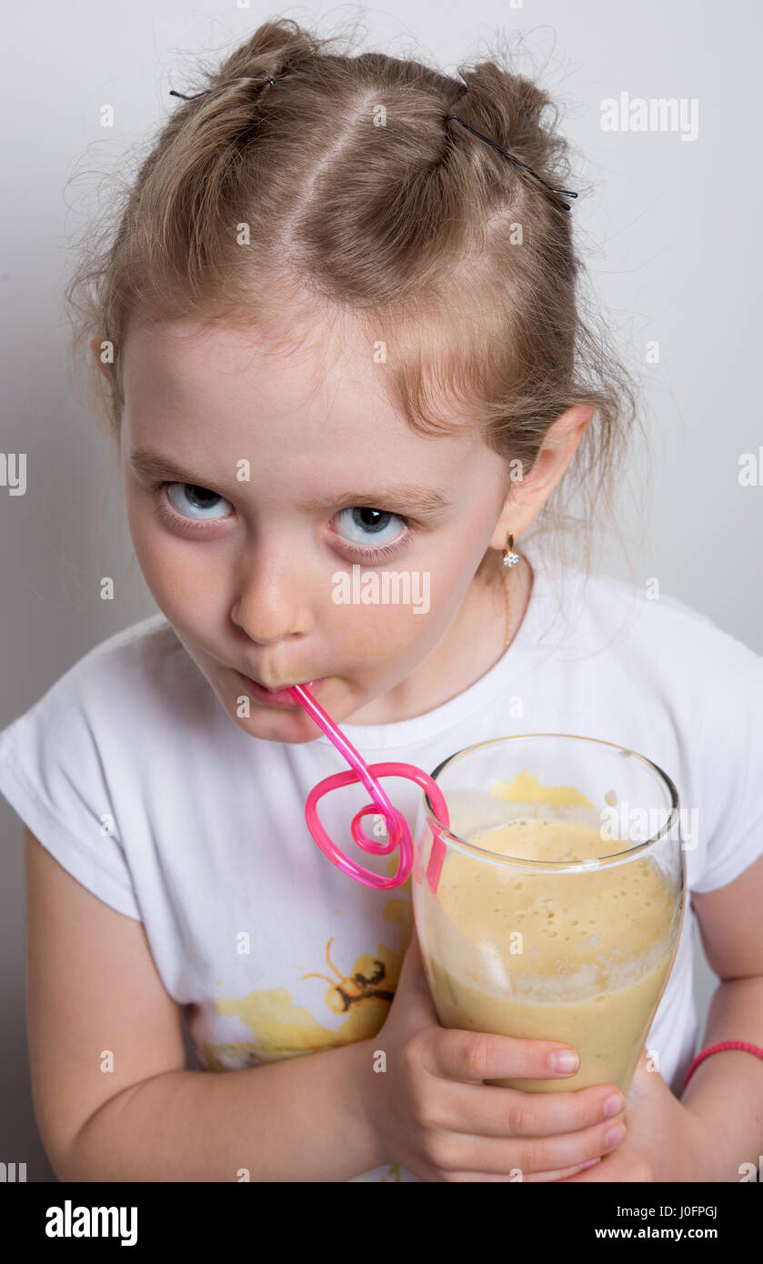 child drinks from a large glass of milkshake Stock Photo - Alamy