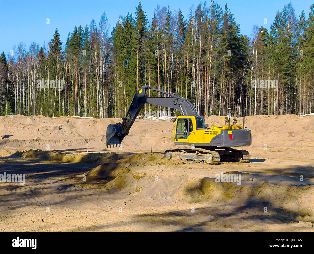 Nice yellow excavator digging sand Stock Photo - Alamy