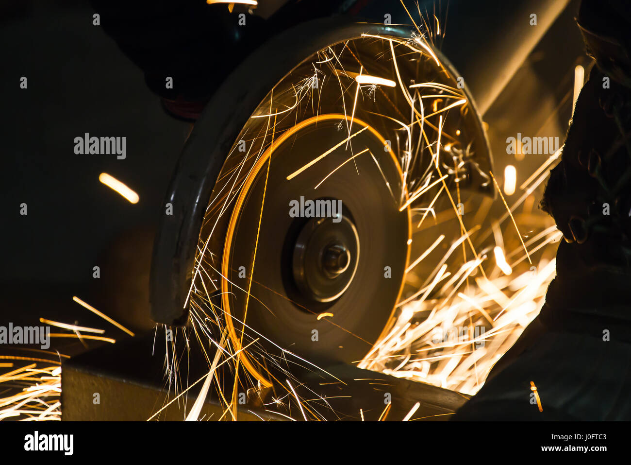 sharpening and cutting of iron by abrasive disk machine Stock Photo - Alamy