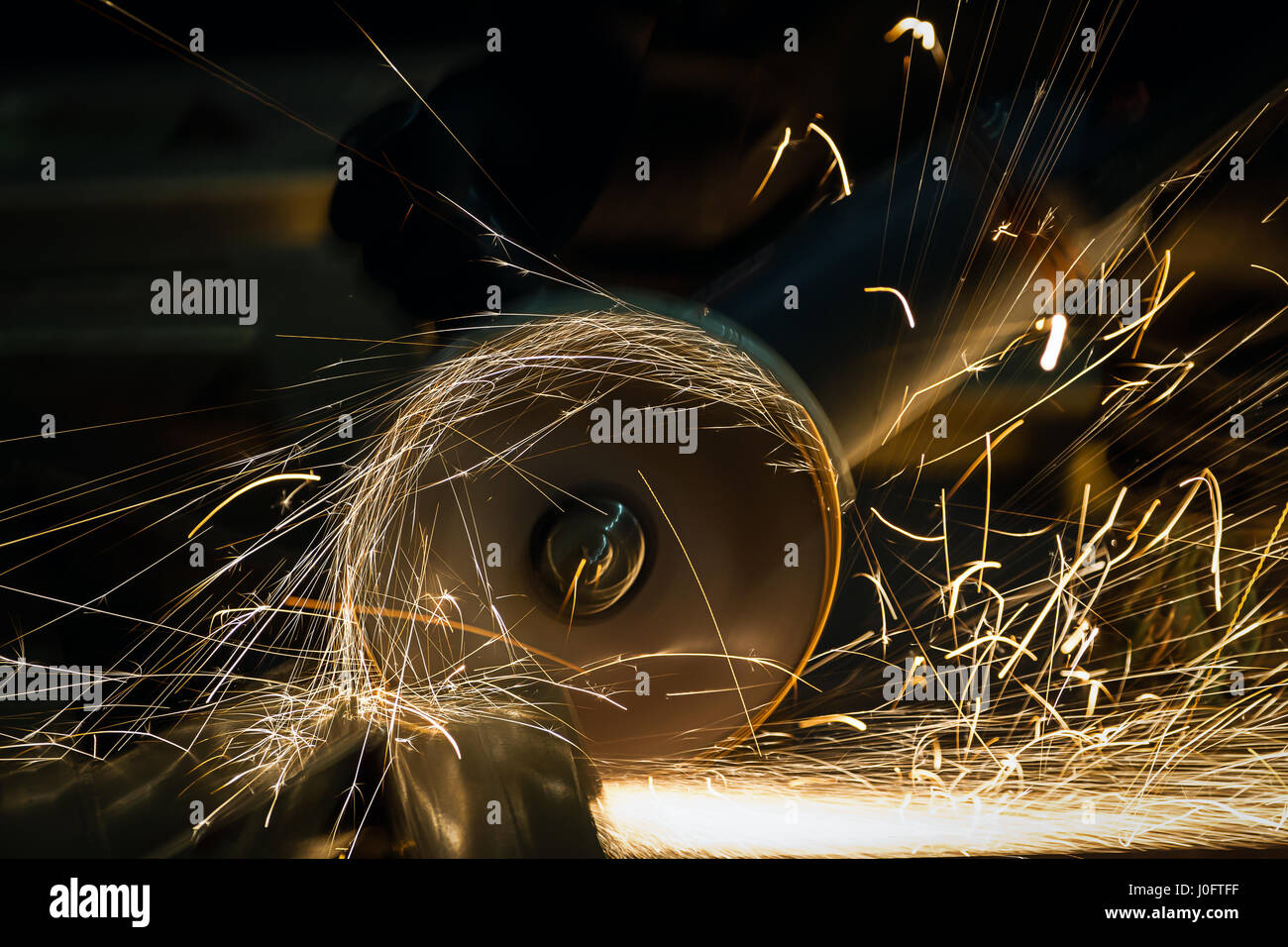 sharpening and cutting of iron by abrasive disk machine Stock Photo - Alamy