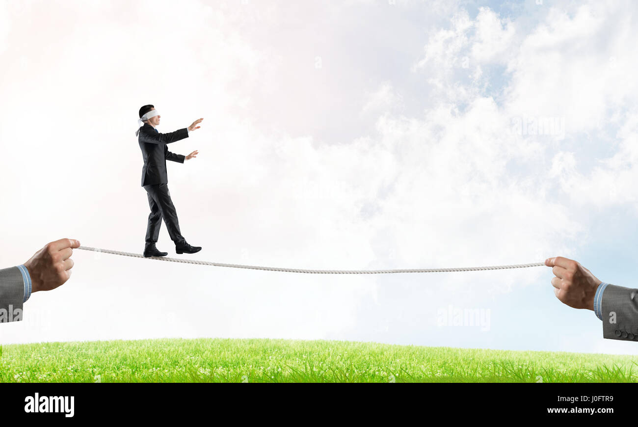 Business concept of risk support and assistance with man balancing on ...