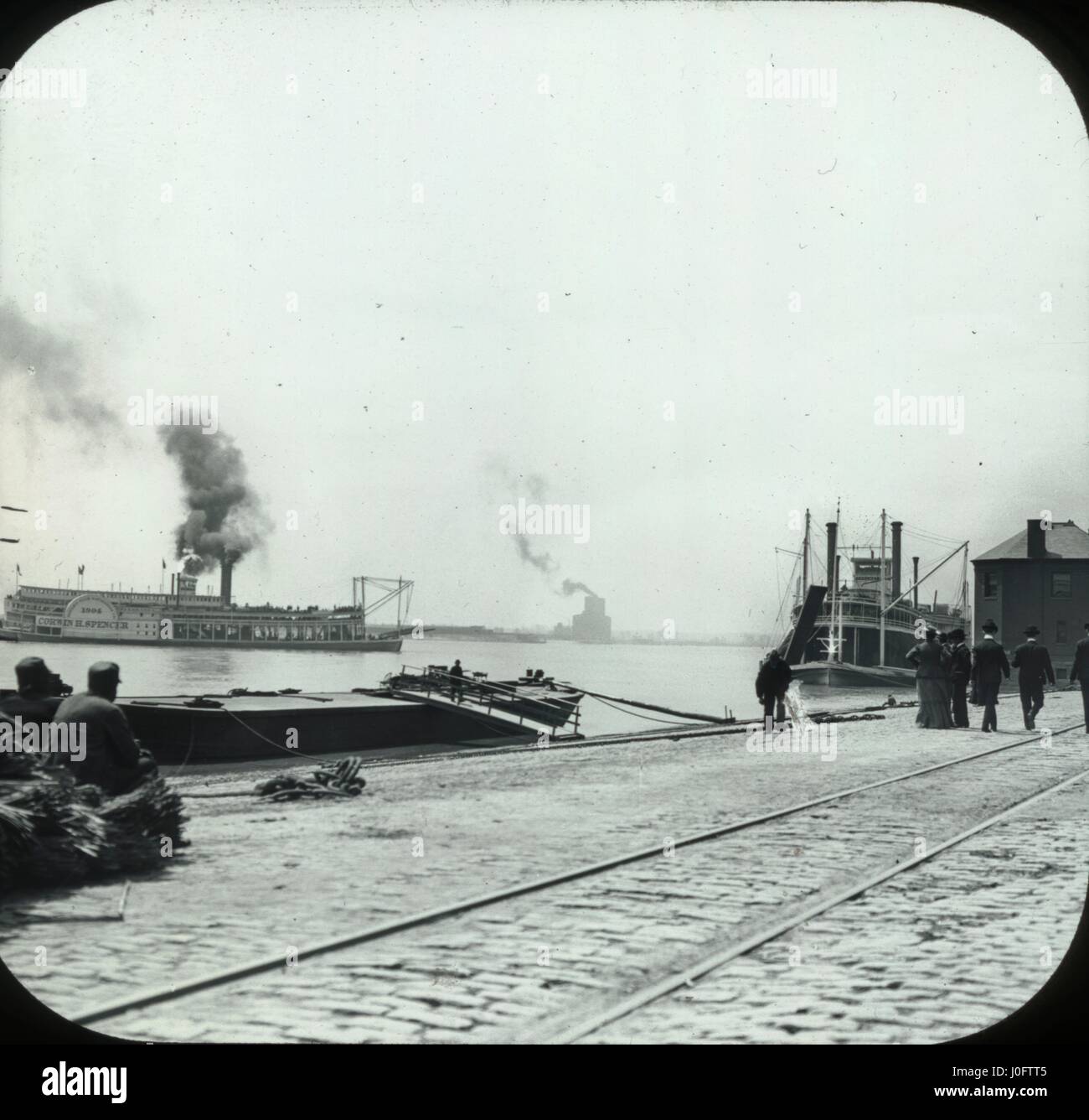 People walking along docks, steamboats in water Stock Photo - Alamy