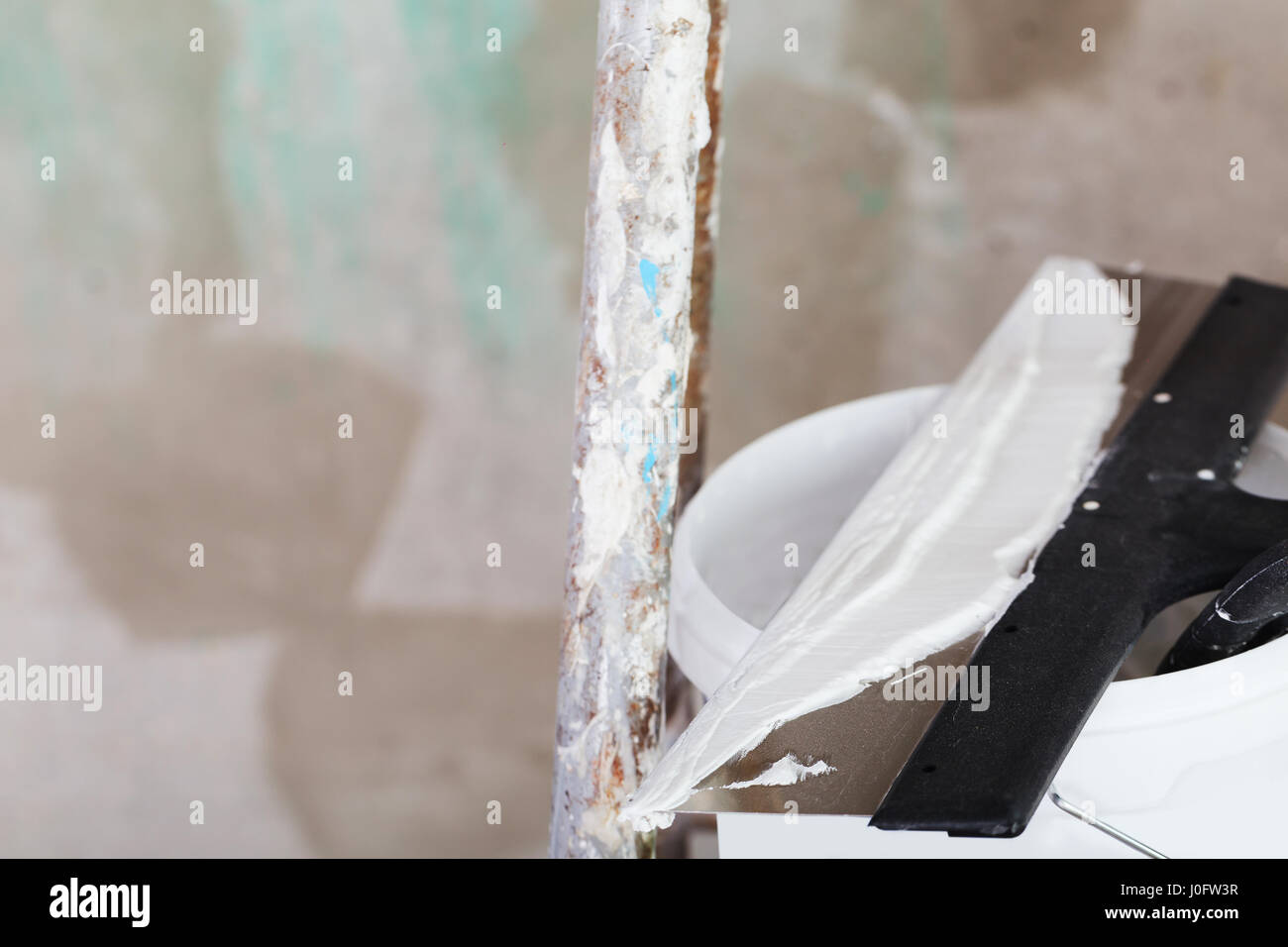 house improvement. stucco bucket and plastering trowel Stock Photo - Alamy